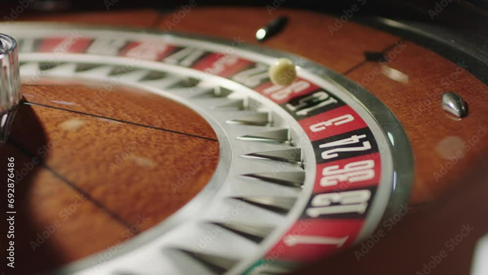 Slow motion closeup shot of the white ball drops to number 34-red while ...