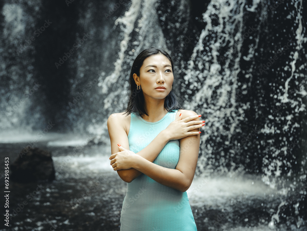 Portrait of Asian woman posing near the waterfall. Nature and ...