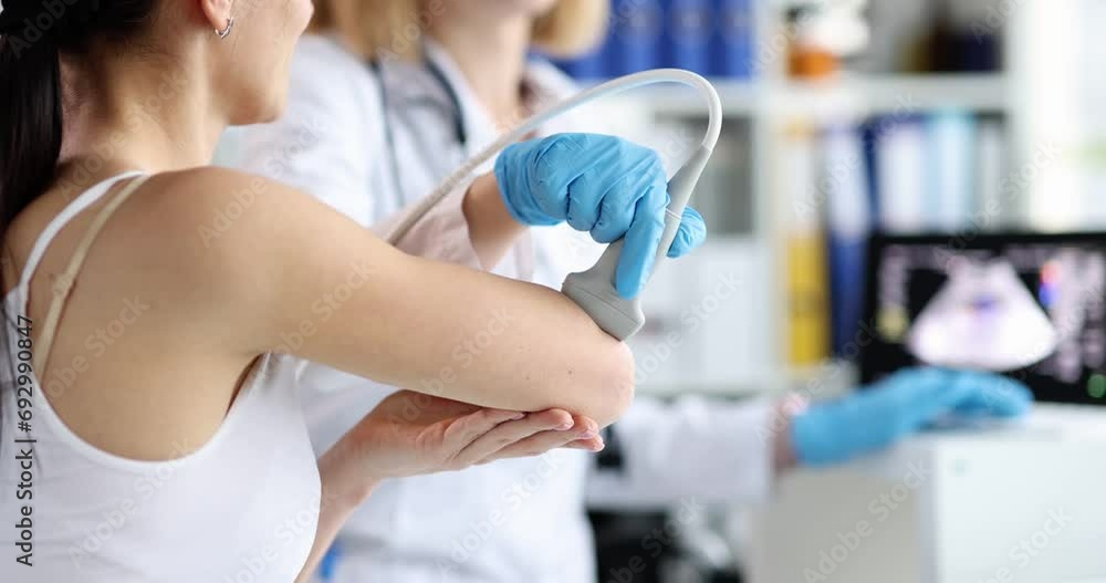 The doctor makes an ultrasound of the arm vessels, close-up, slow ...