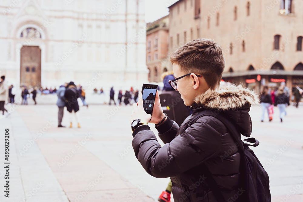 Boy enjoying view on the The Basilica of San Petronio at the center of ...