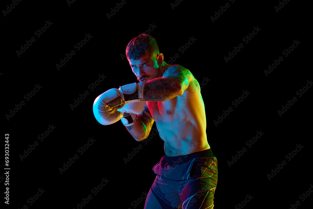 Young man, shirtless boxing athlete with muscular body training ...