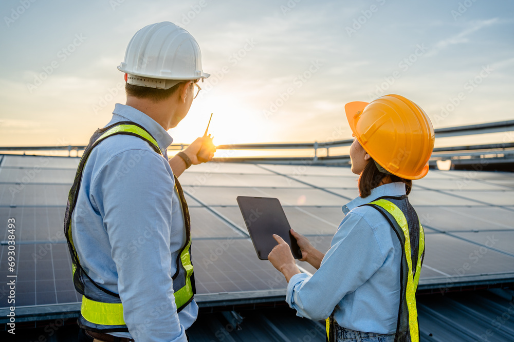 Multiracial electrical engineers working together use laptops to ...