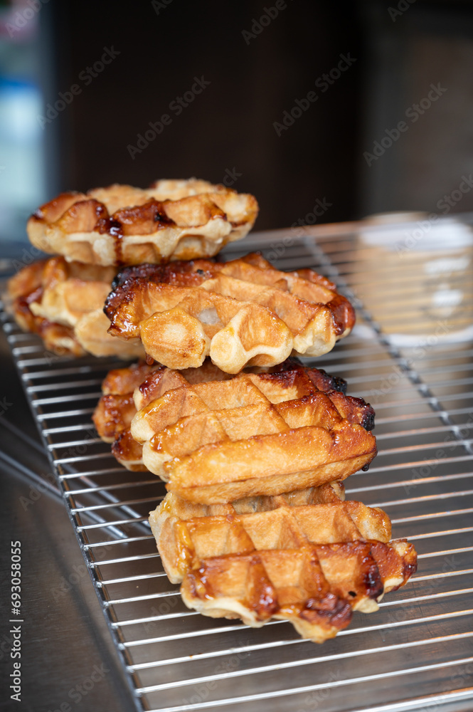 Eating of fresh baked hot Belgian sugar waffles, street food in Bruges ...