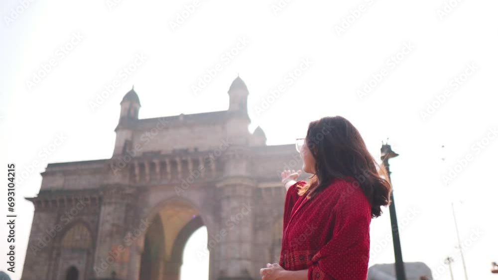 Portrait of smiling Indian girl showing Gateway of India in Mumbai ...