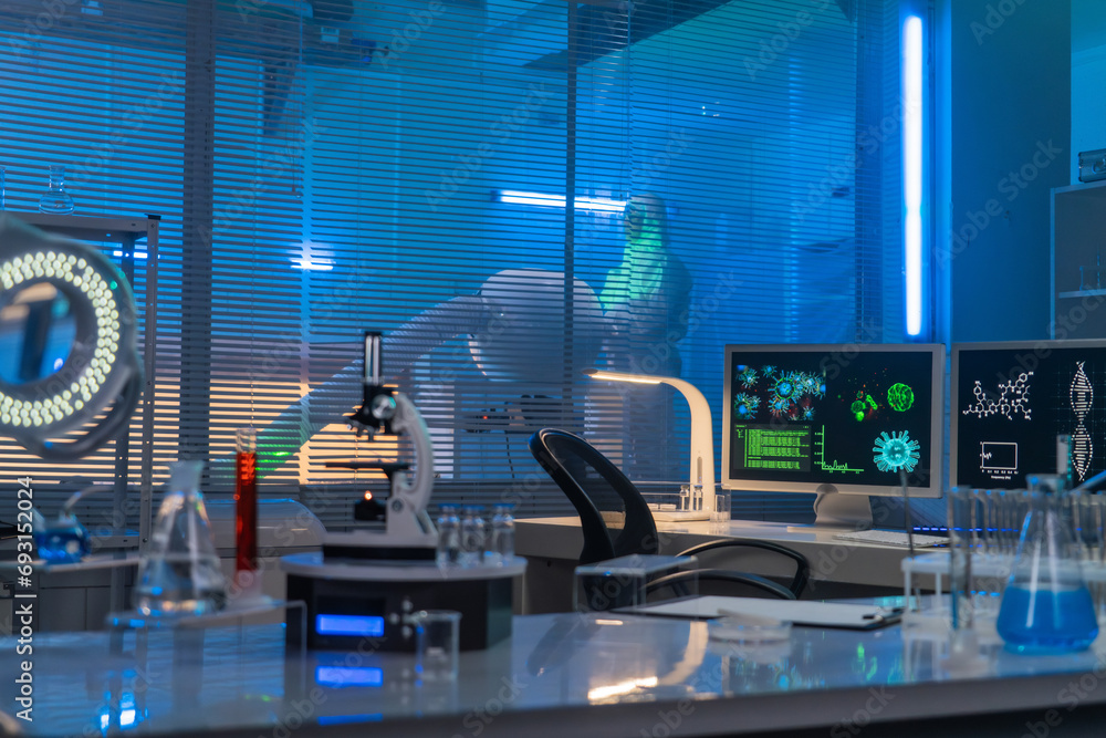 The shot shows a laboratory room with brightly lit lamps and various ...