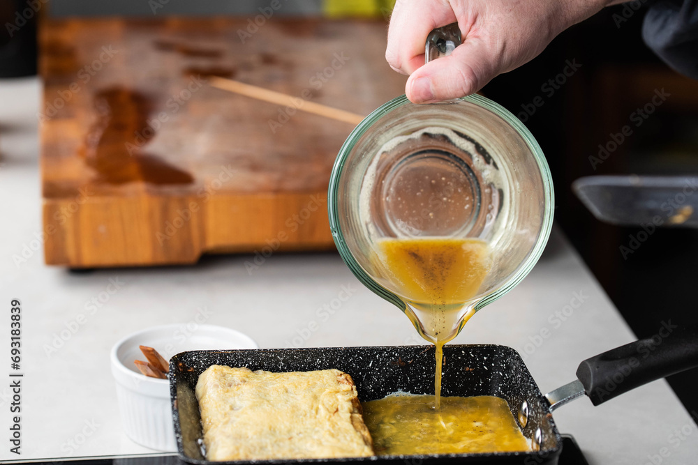 Chef man hands cooking Tamagoyaki or Tamago traditional Japanese Rolled ...