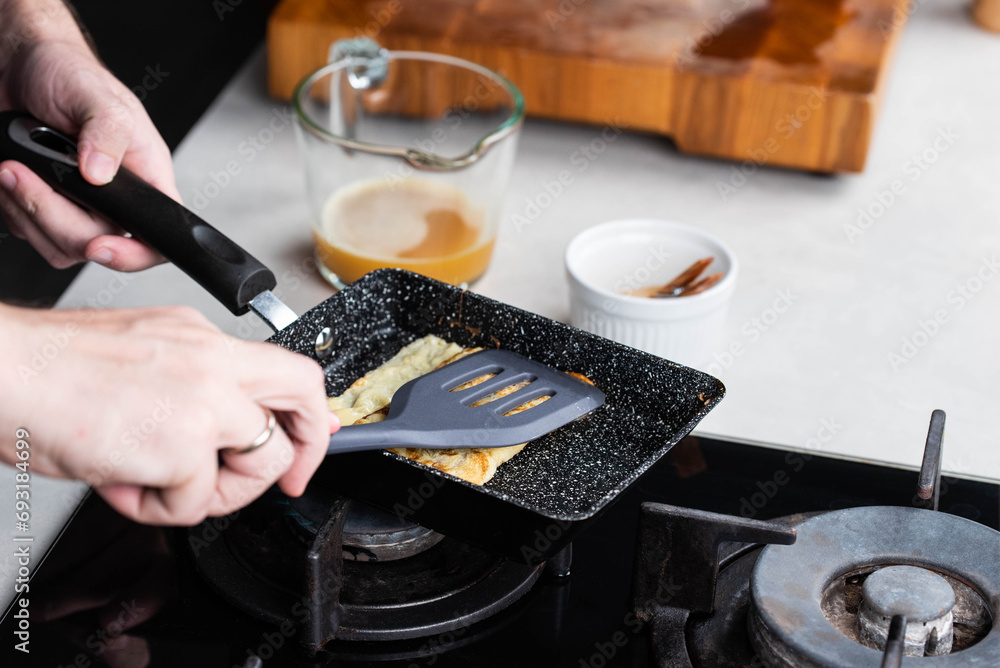 Chef man hands cooking Tamagoyaki or Tamago traditional Japanese Rolled ...