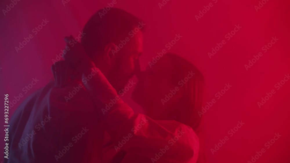 Couple kissing foreplay on neon light background. Young caucasian man ...