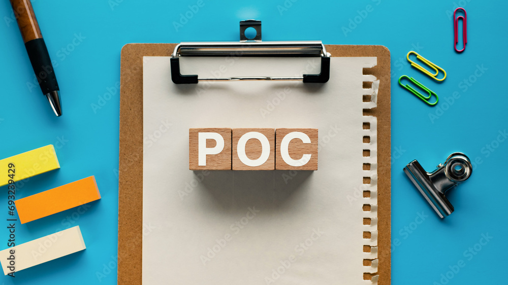 There is wood cube with the word POC. It is an abbreviation for Proof ...