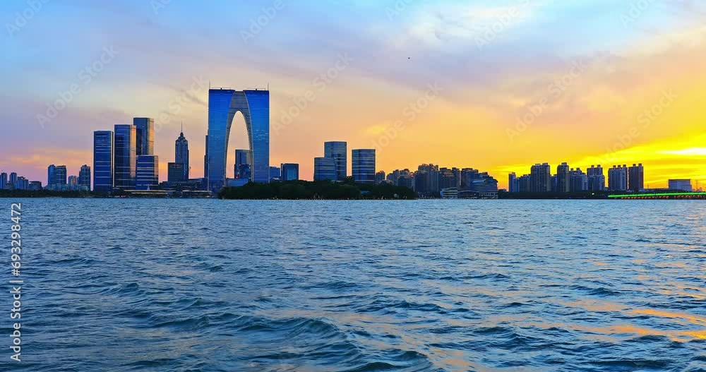 Suzhou skyline and modern buildings scenery at sunset by the lake ...