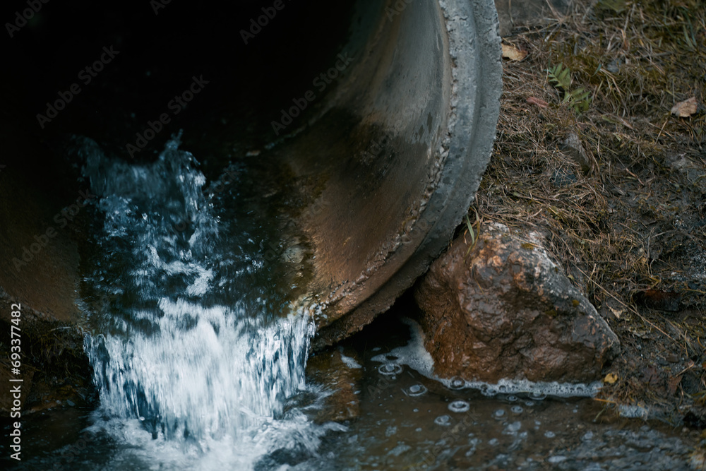 Wastewater sewage flows from a pipe into the river. Tackling Pollution ...