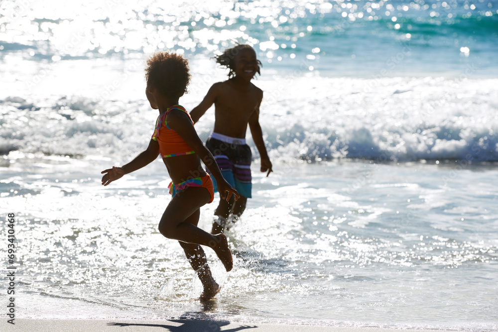 African kids, beach and playing in water at sea, smile and having fun ...