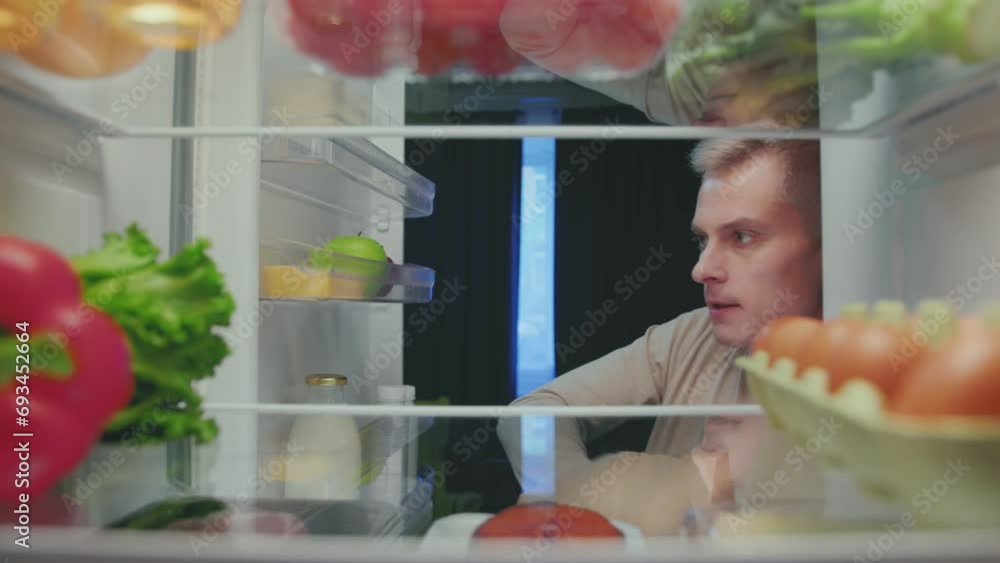 Man Opening Fridge Door and Putting Food Products of Paper Bag to ...