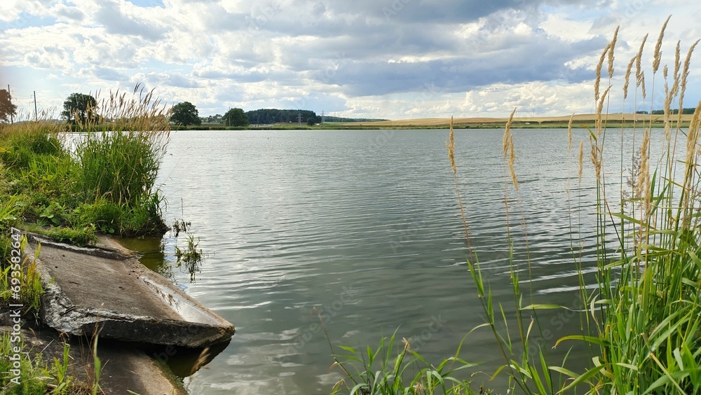 A storm cloud hangs over the lake. The water ripples in the wind. In ...