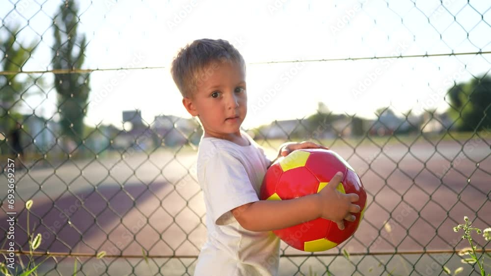 the boy stands near the playground. concept of a happy childhood and ...