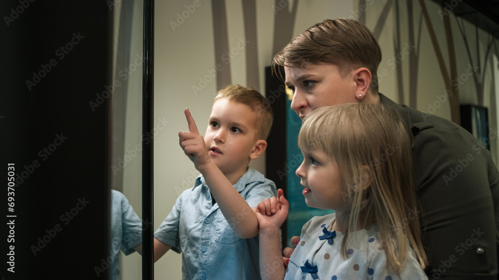 Family, cute blonde little boy and his toddler sister having fun with ...