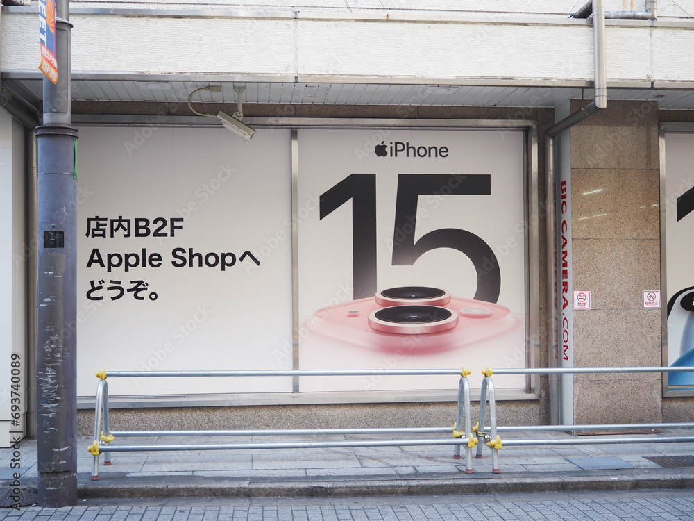 TOKYO, JAPAN - December 10, 2023: An advert for the iPhone 15 on a branch of the Japanese ...