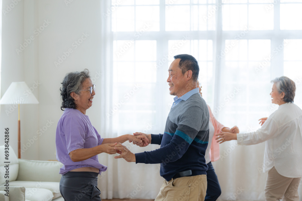 Asian Older male and females people dance with their partners on a ...