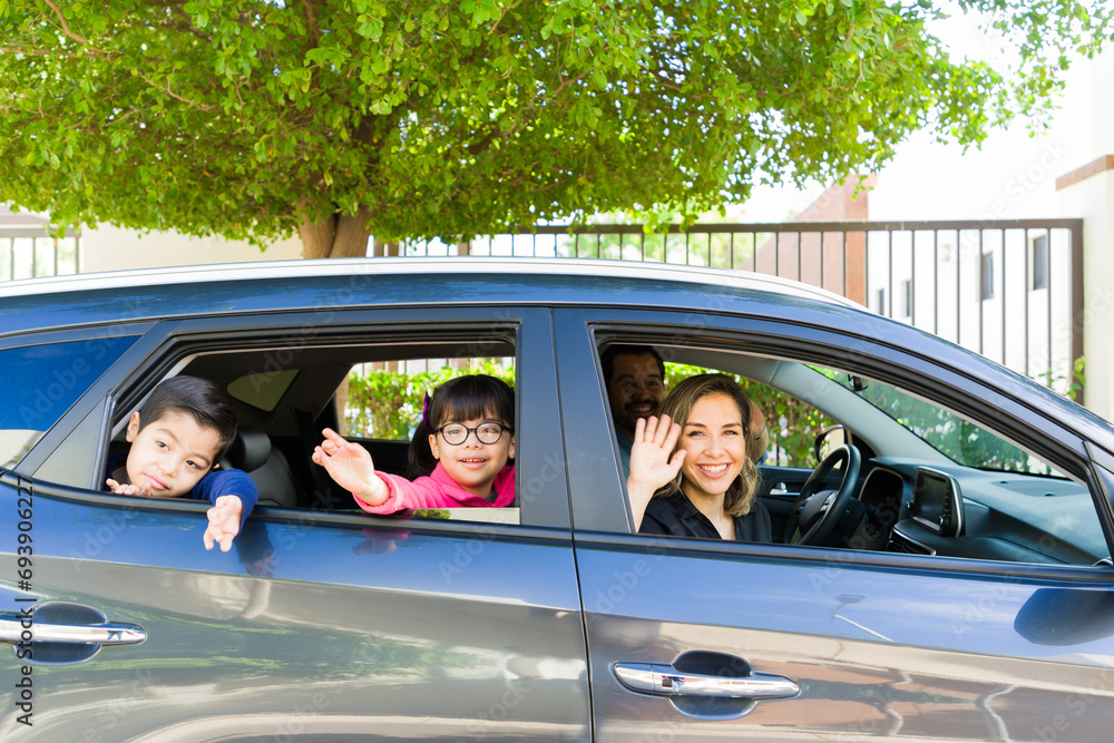 Beautiful family waving goodbye driving in the car Stock Photo | Adobe ...