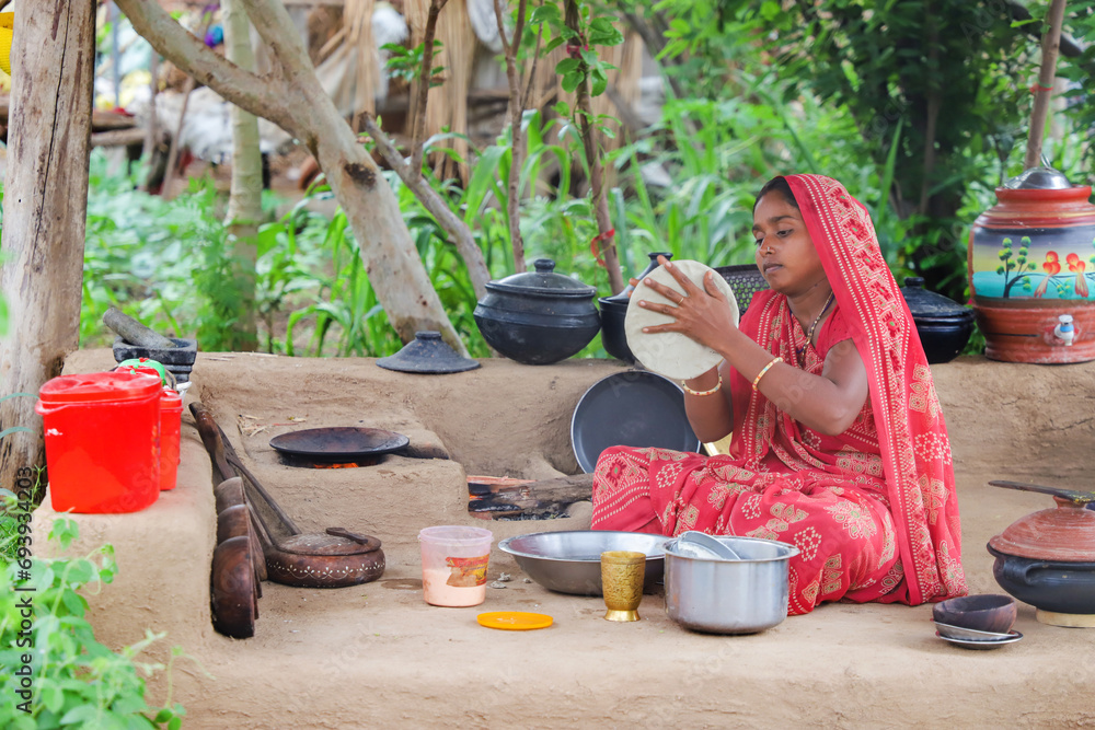 Rural Indian Woman cooking food in the Kitchen using firewood stove,a ...