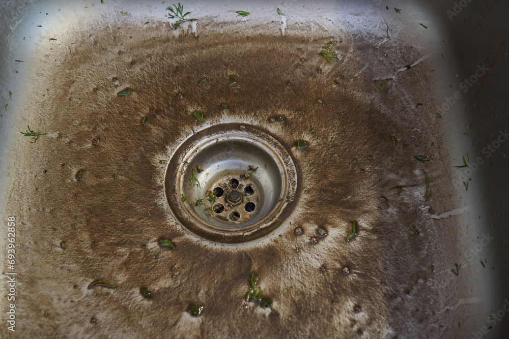 dirty sink in the kitchen, a sink with a swamp after washing vegetables ...