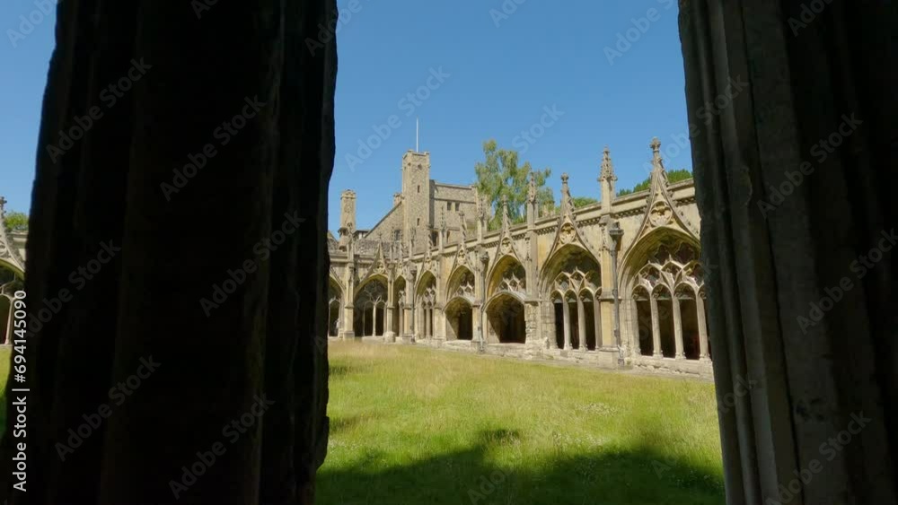 Walking along covered arcade that surrounds a small square grassy ...
