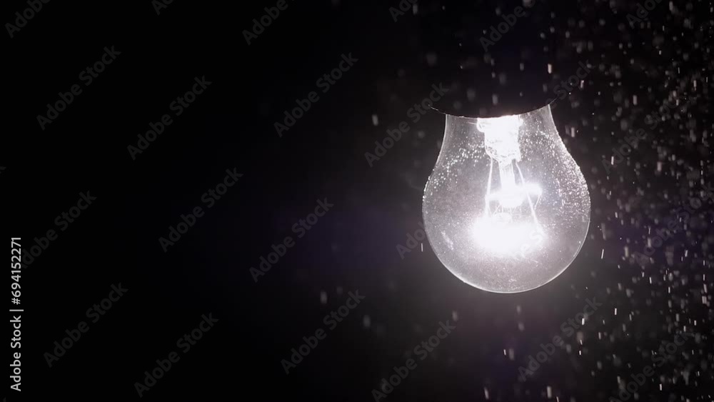 Bright Incandescent Light Bulb Illuminates the Falling Snow in the Dark ...