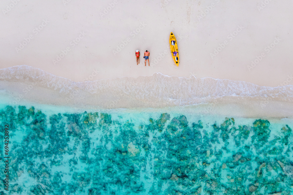drone view at couple laying down on the beach of Koh Phi Phi Thailand ...