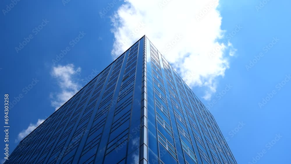 Tall big office building with white clouds, blue clean sky background ...