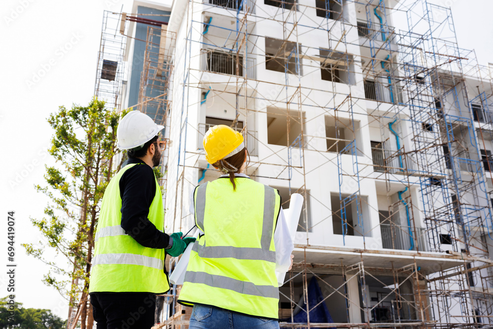 Engineers and Architect Caucasian looking at blueprint of building ...
