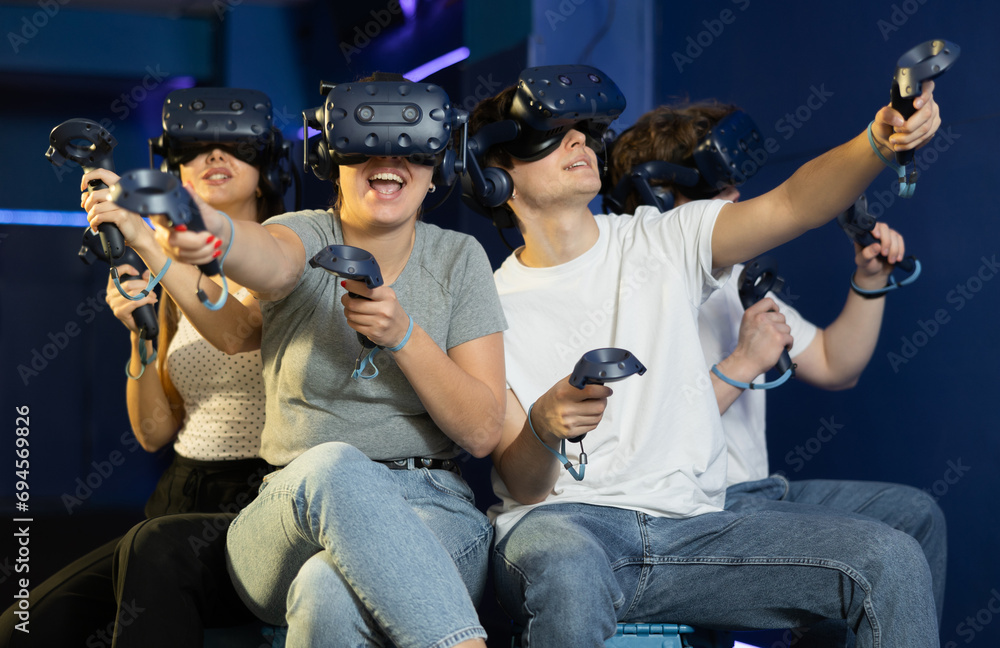 four comrades using virtual reality headset in space adventure game ...
