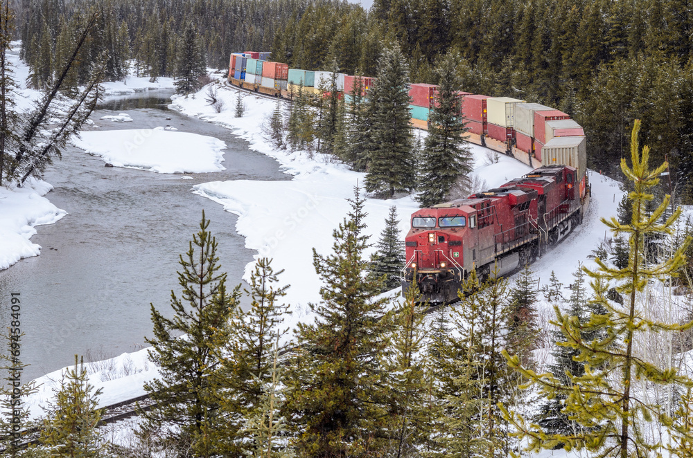 Container train pulled by powerful diesel locomotives on a winding ...