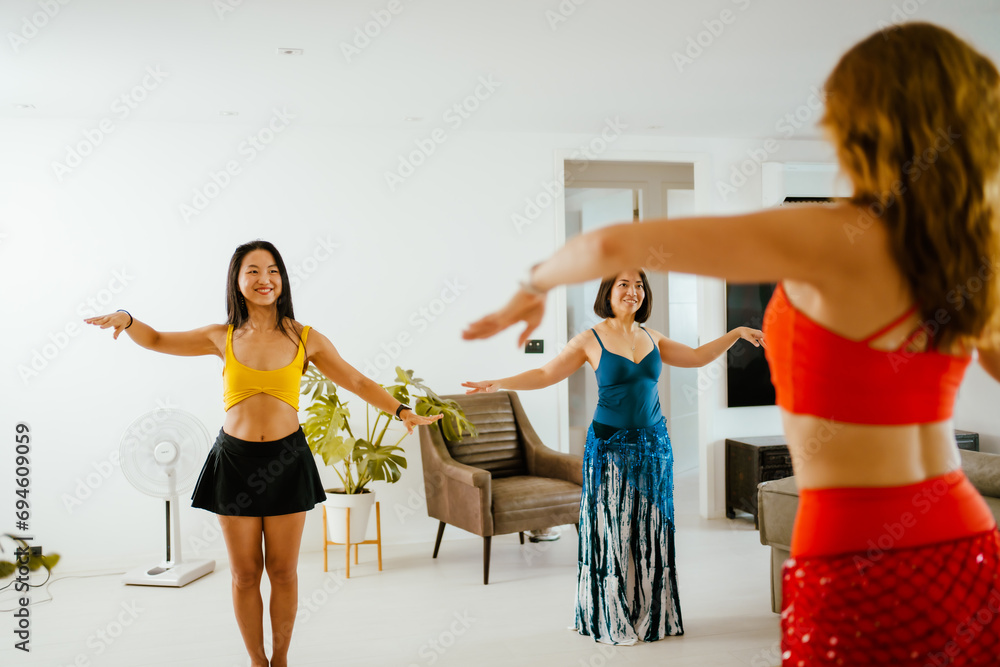 Picture of a group of female friends performing Belly Dance in beautiful costumes. with fun at ...