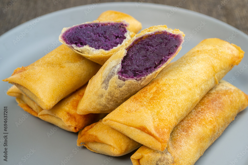 Lumpia ubi ungu is a snack made from purple sweet potato cooked by ...