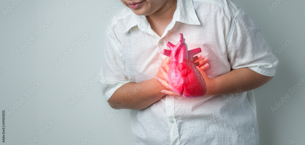 heart disease concept. woman pressing on chest with painful expression ...