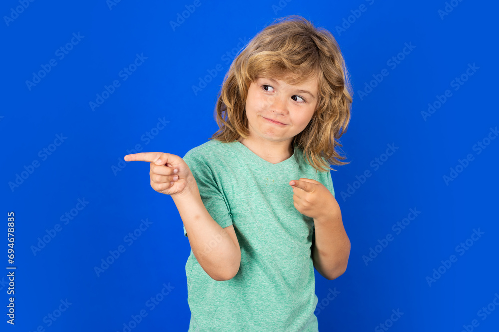 Child boy pointing away on isolated studio background. Kid with index ...