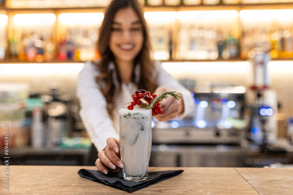Barmaid preparing cocktails in a bar for her clients - Bartender at ...