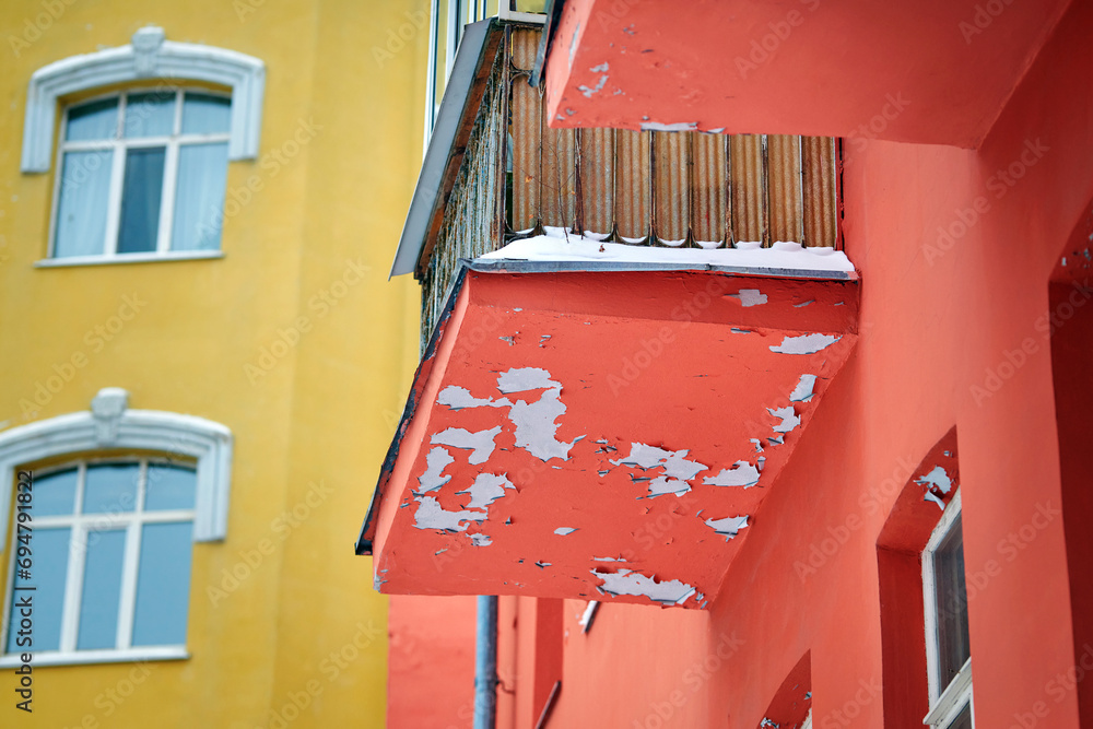 Balcony with cracked plaster and damaged paint. Facade renovation ...