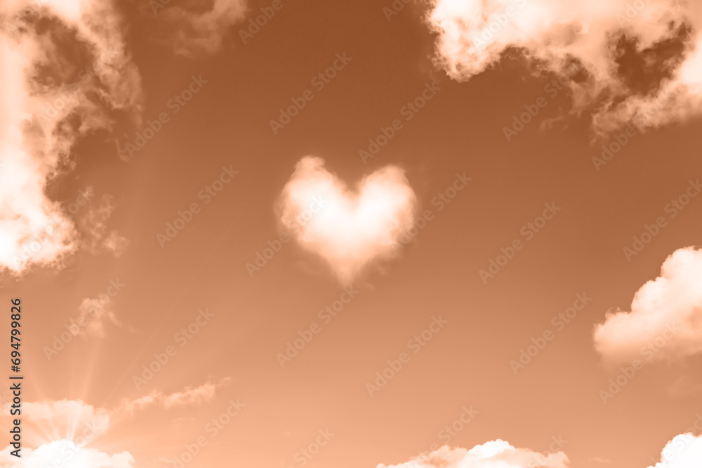 Beautiful beige sky with a white cloud in the shape of a heart. Natural ...