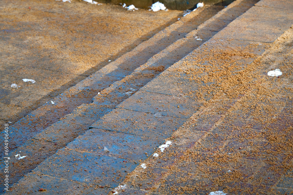 Sand sprinkled on stairs to prevent slipping on slick steps. Spread ...