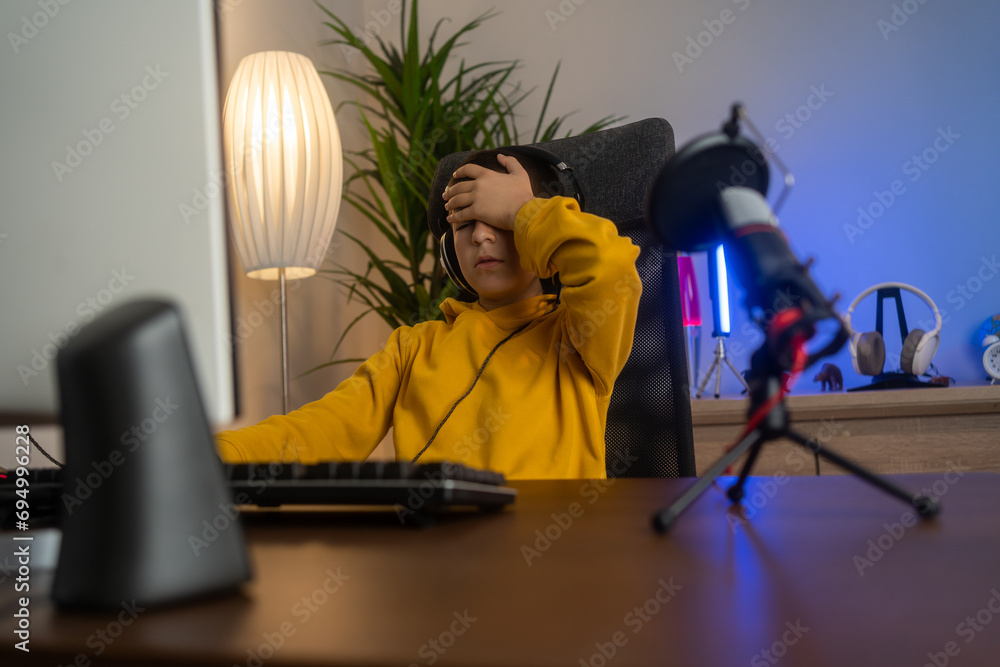 Stress, gamer or boy with headache from loss, fail or online ...