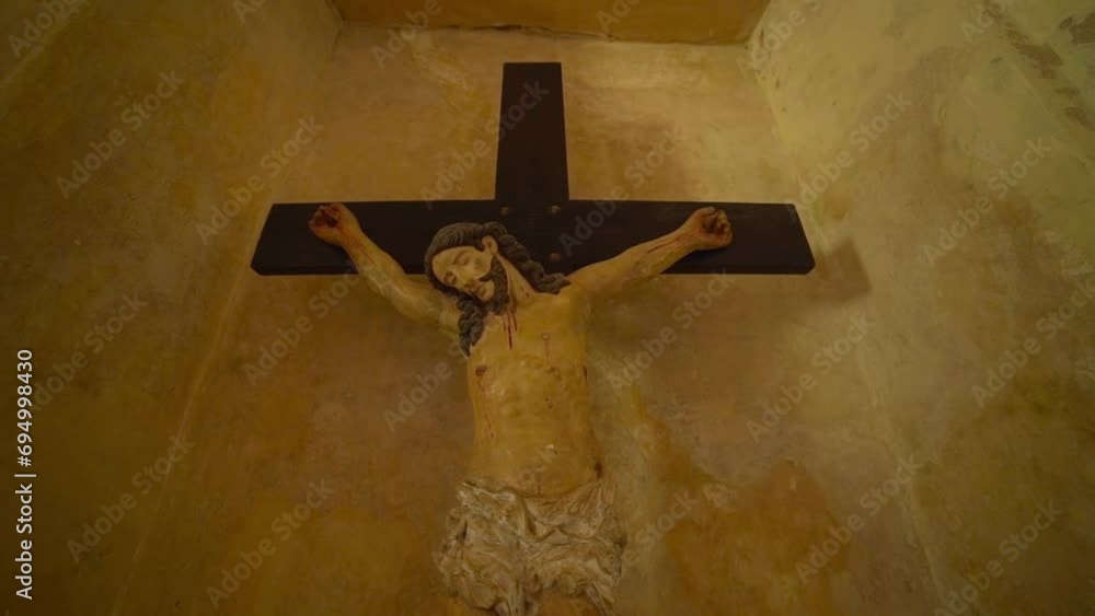 statue of Jesus Christ crucified on the cross on the wall of a church ...