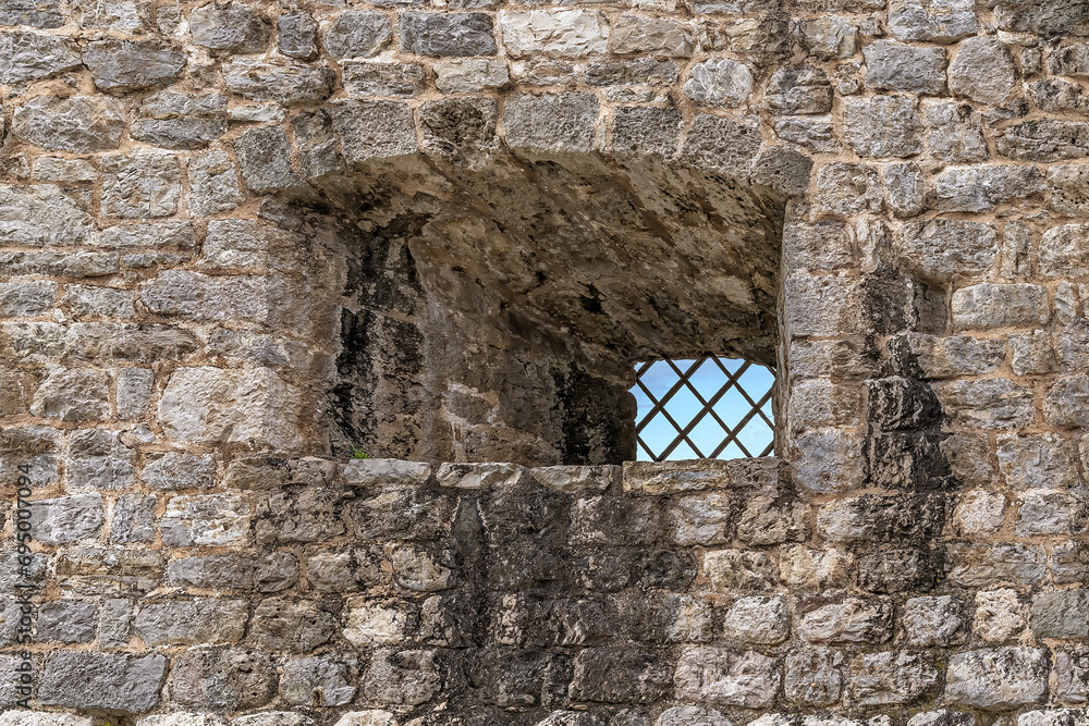 Loophole with a lattice in an ancient stone wall of the Old Town of ...