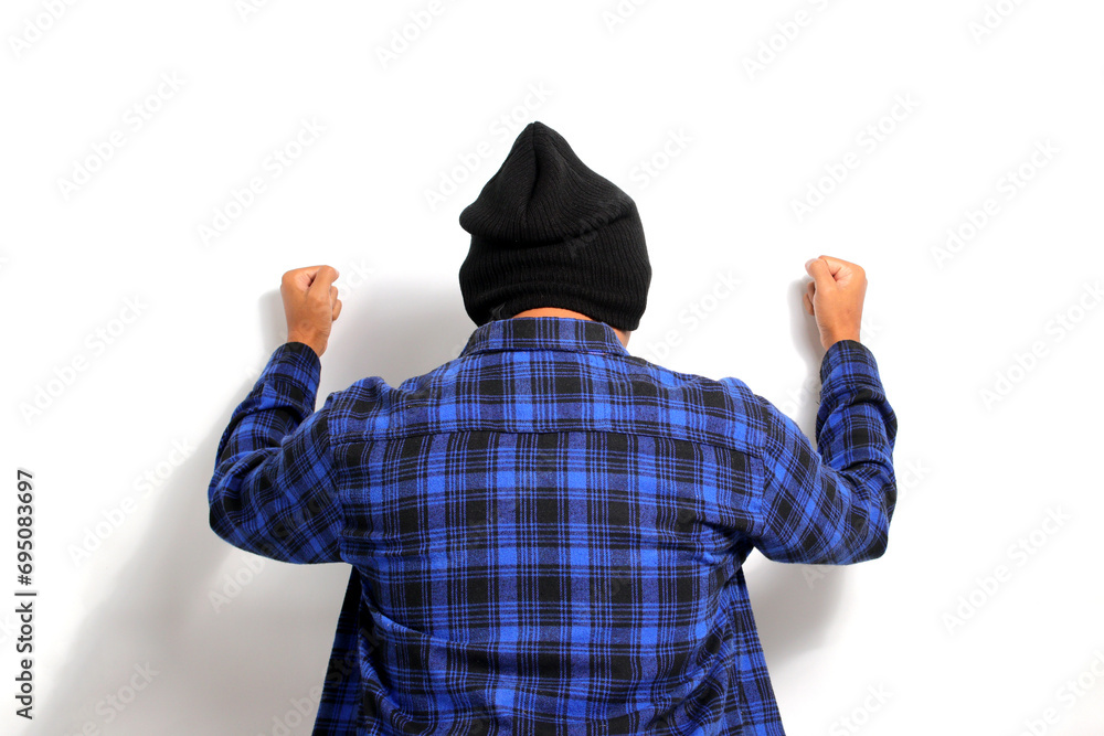 Knock-knock. Who's there? Back view of an excited young Asian man is ...