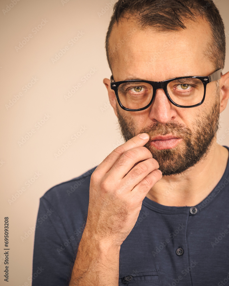 Adult clever guy wearing eyeglasses and blue shirt having thinking ...