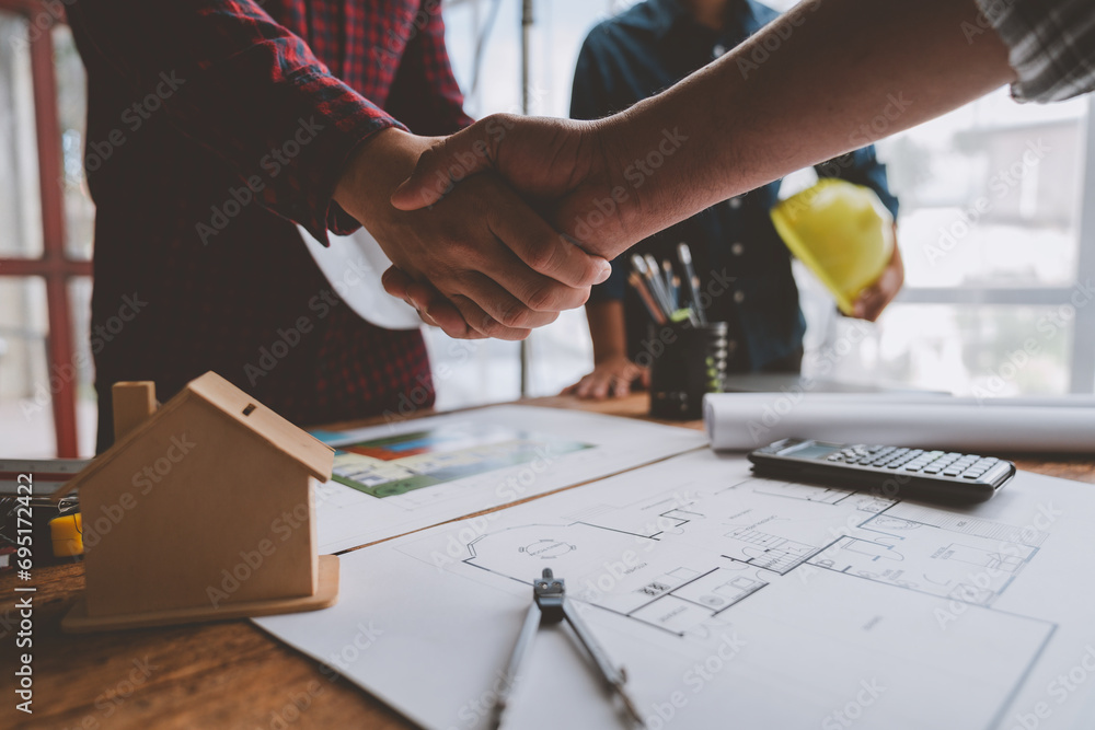 Architect and engineer construction workers shaking hands after ...