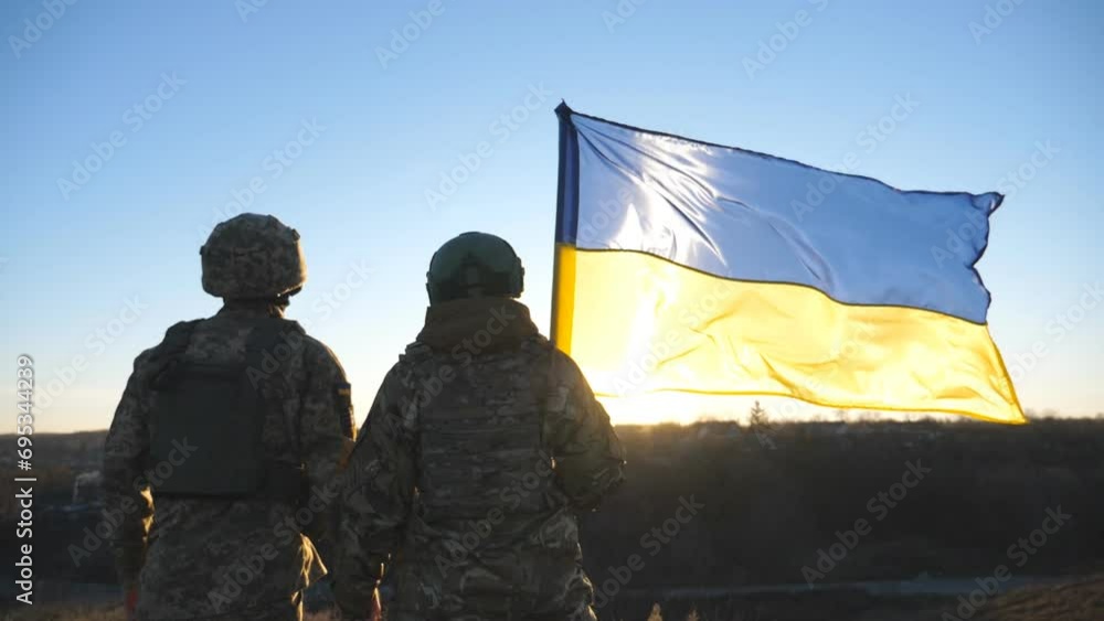 Military couple of ukrainian army holds hands of each other standing at ...