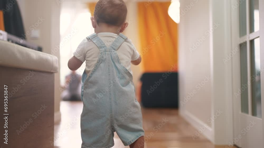 baby first steps. baby goes to her father at window learns to walk to ...