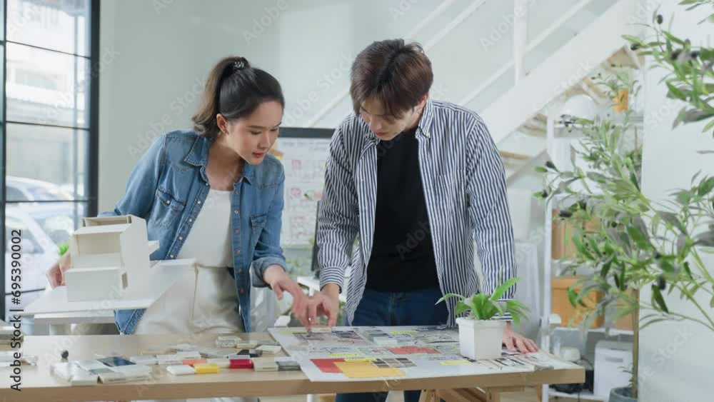 Asian architects in office discussing construction project.Young asian ...