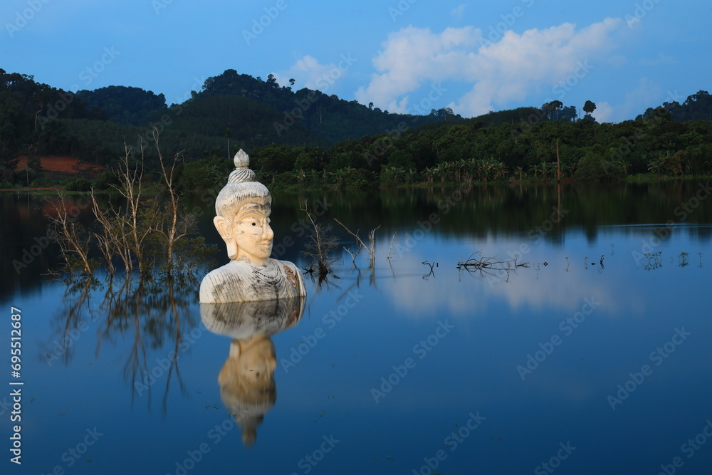 Sinking Buddha statue (Drowning Buddha) and reflection.A large Buddha ...